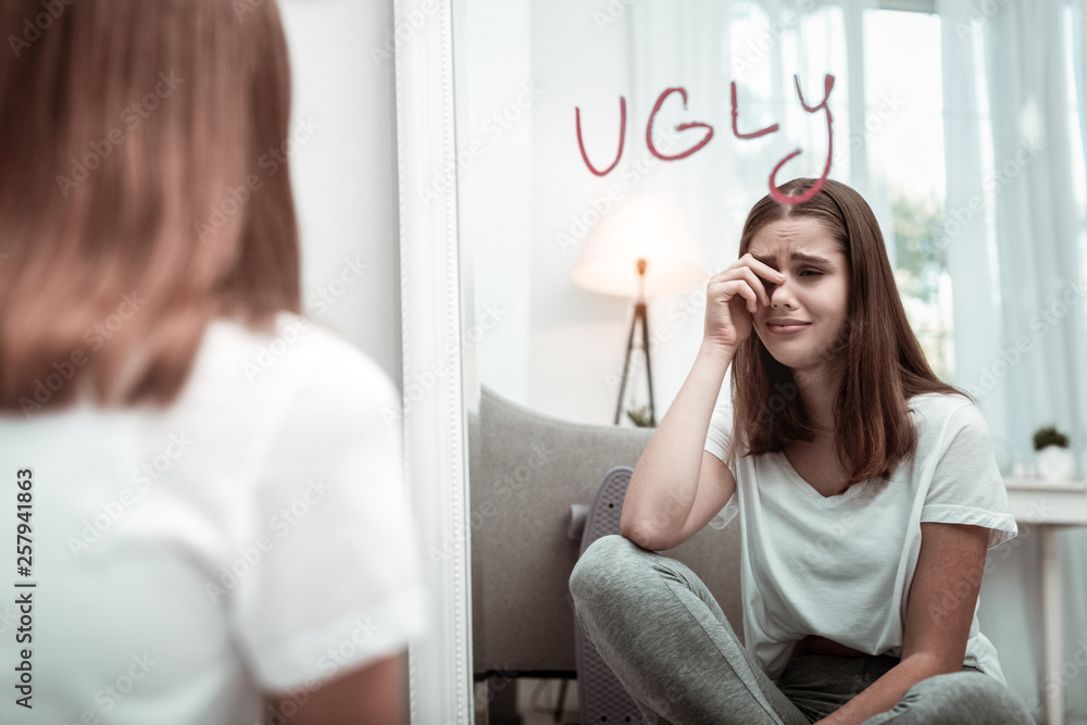 Woman feeling depressed because of feeling ugly Stock Photo | Adobe Stock