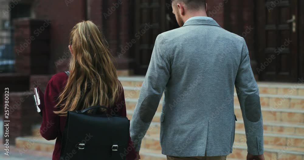 Back view on the caucasian father walking with his daughter hand in ...