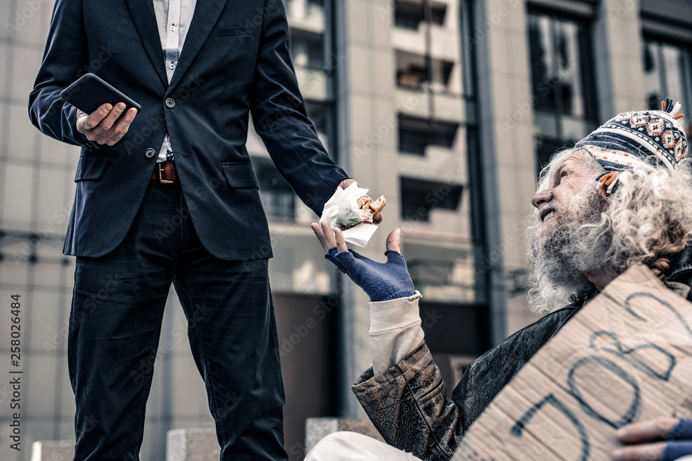 Desperate starving old man sitting on cold ground and begging for food ...