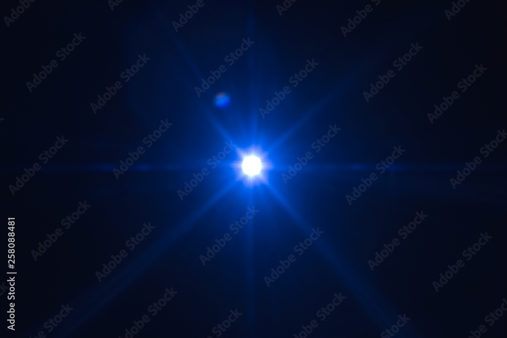 Single blue spark on black background. Lens flare effect. Defocused ...