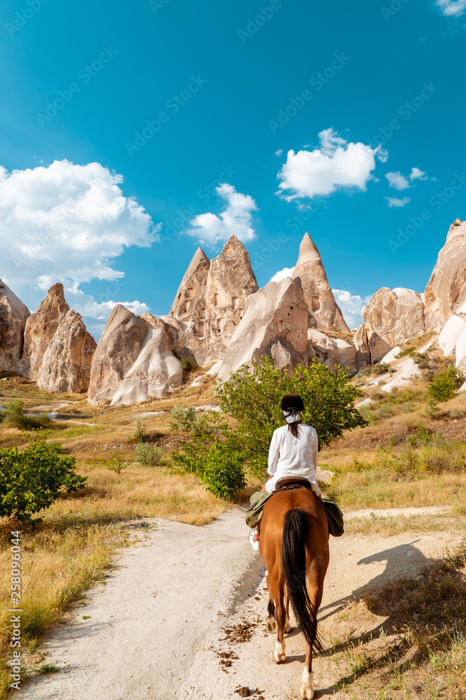 happy young couple man and woman Horseback riding through the national ...