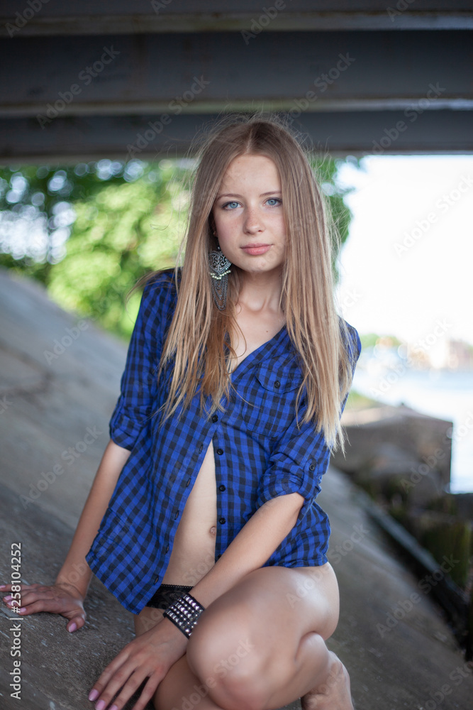Beautiful and shy blond girl posing at the park Stock Photo | Adobe Stock