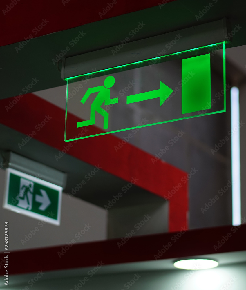 Illuminated Fire exit sign for use in emergency Stock Photo | Adobe Stock