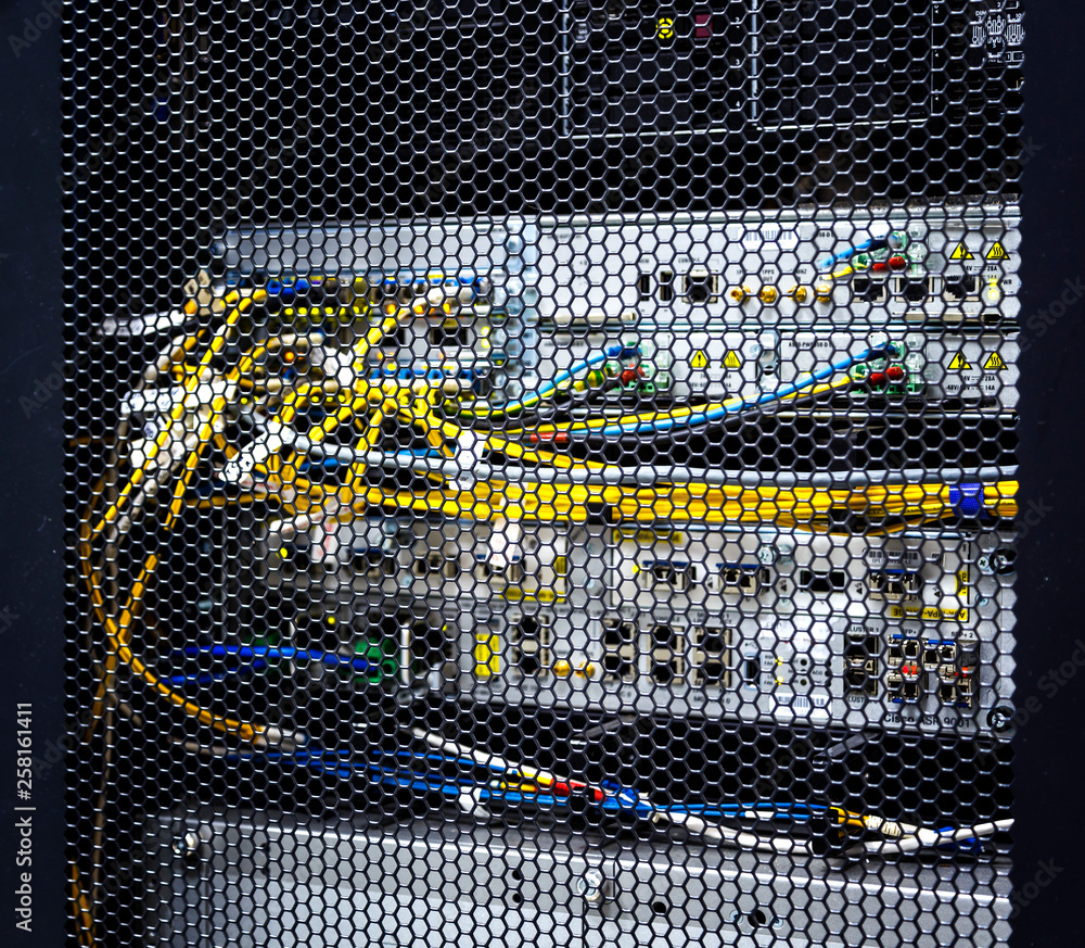 Looking through honeycomb pattern doors inside modern big data server ...