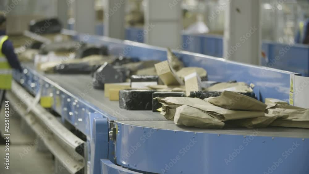 Parcel Mail Distribution Centre. Packages on a conveyor belt at a mail ...