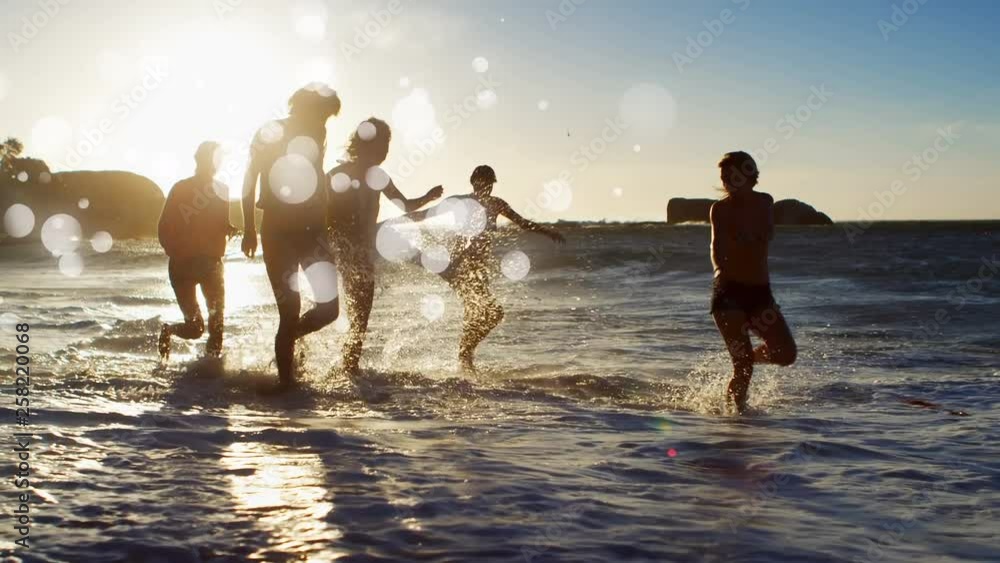 Women playing on the beach at susnet against white bubbles Stock Video ...