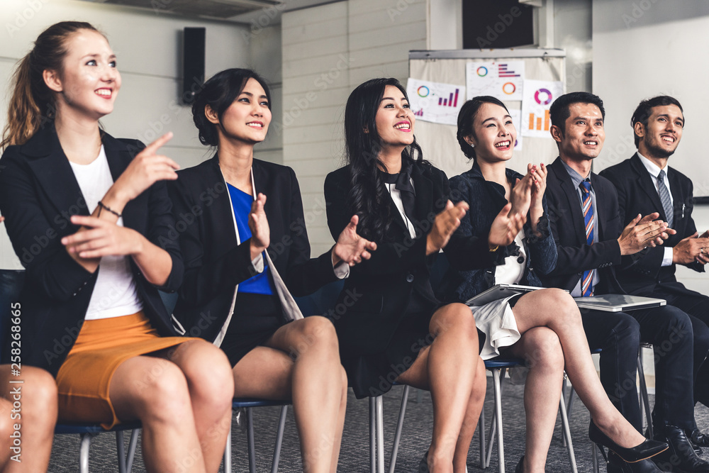 Professional young Asian and Caucasian audience applauding in group ...