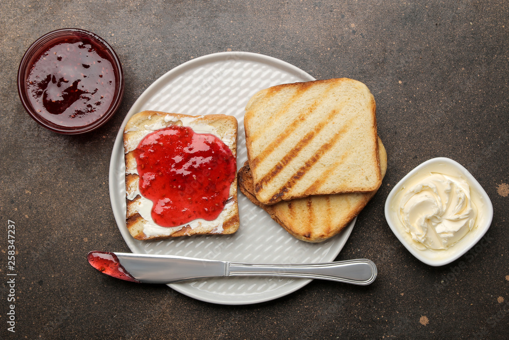 toasts with jam. fried crispy toast with red jam on a dark background ...