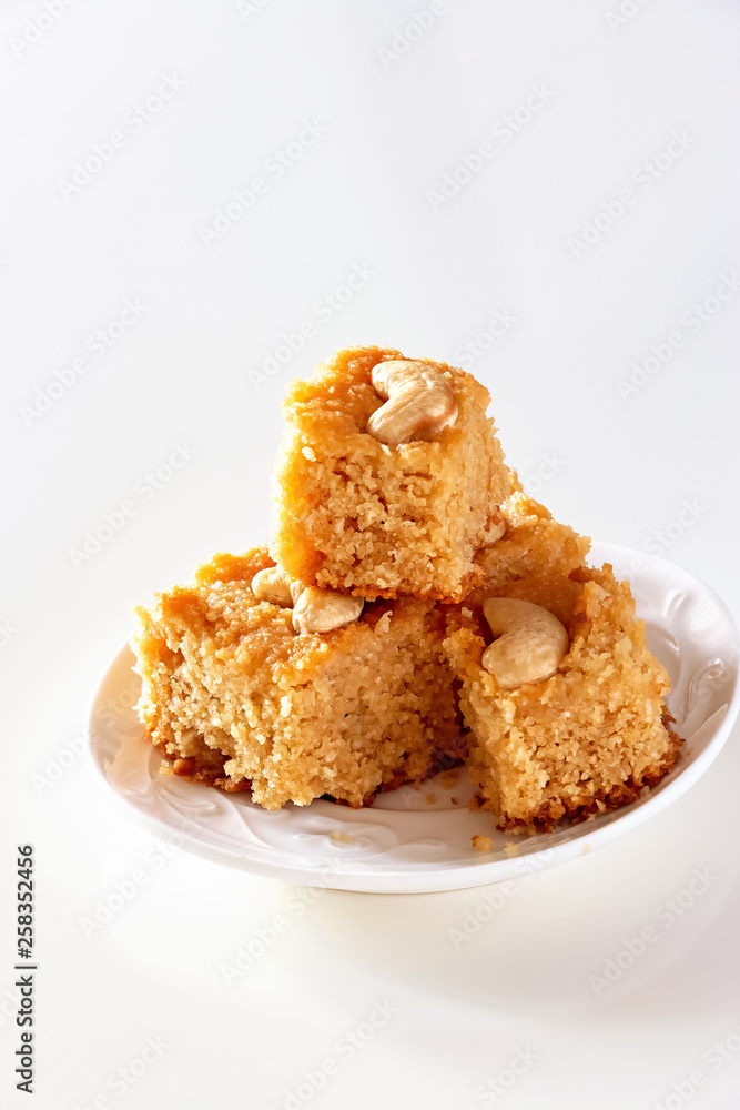 Basbousa or namoora traditional arabic semolina cake with cashew nuts ...