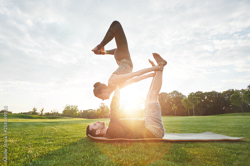 Balancing Yoga Poses. Healthy and young couple practicing acro yoga ...