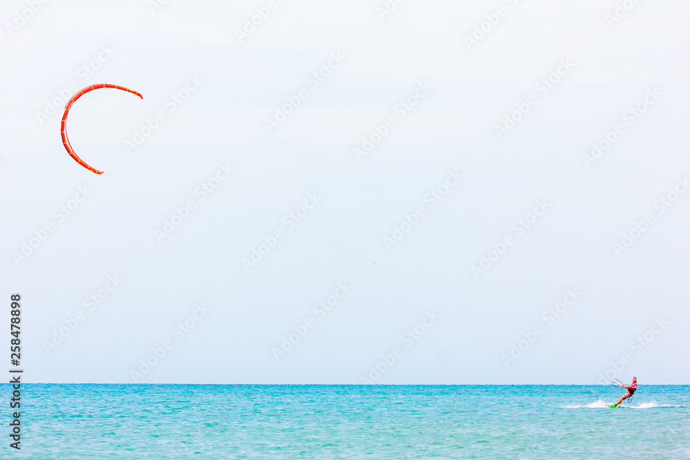 brave man kite sailing on the black sea with a sail wing in his hands ...