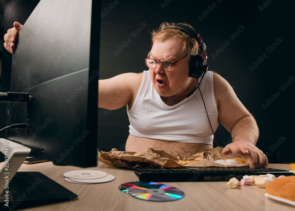 angry and furious man sitting with a computer at home. close up side ...