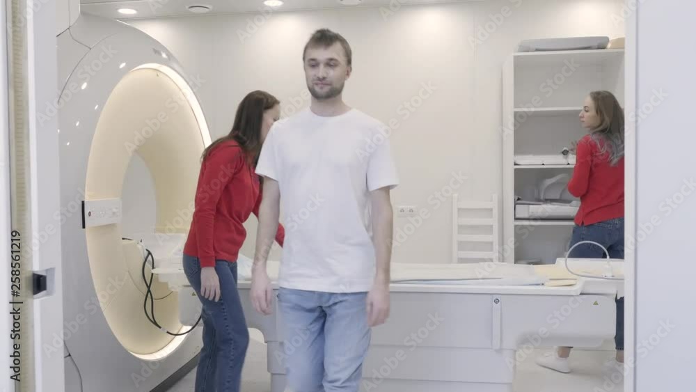 Male patient standing after magnetic resonance imaging scanning process ...