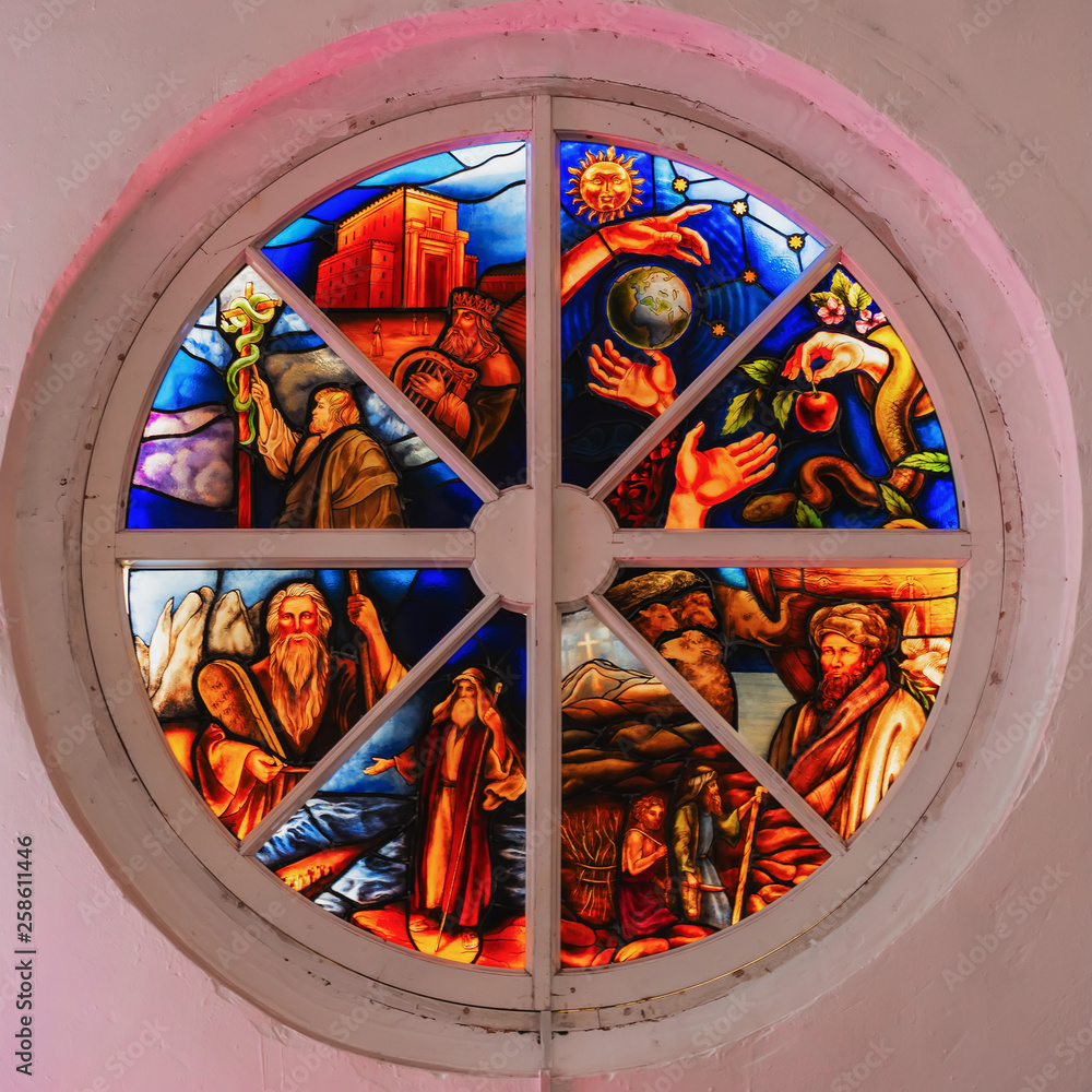Old round stained glass window in a destroyed in the church, bright ...
