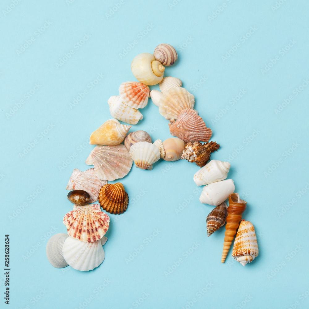 Letter 'A' from sea shells on blue background. Alphabet in marine style ...