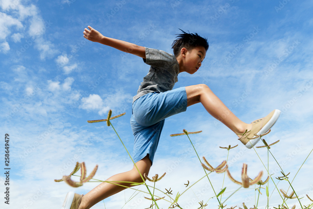 Young boy run and jump Stock Photo | Adobe Stock