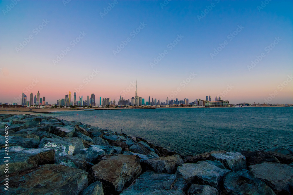 Futuristic Skyscraper buildings view from beach island with blue ...