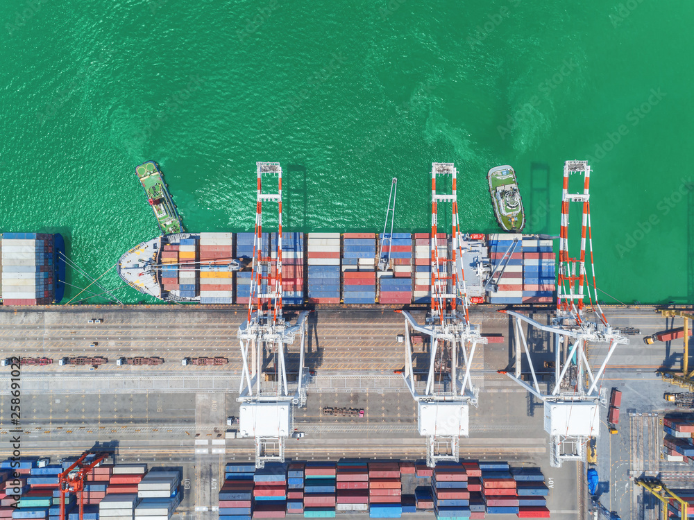 Aerial top view Tugboat drag Container Ship at sea port or Container ...