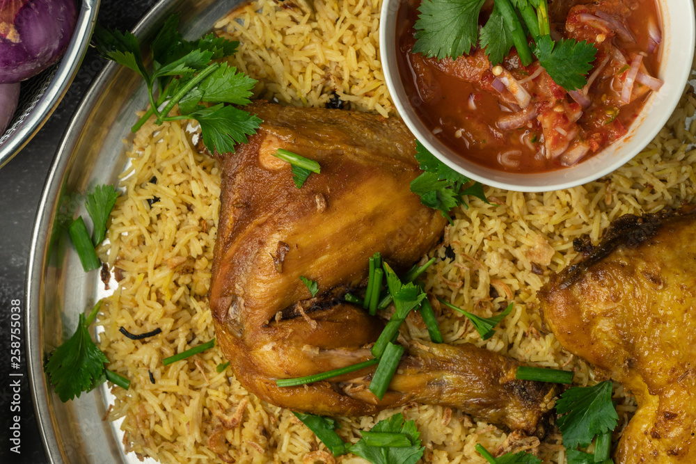 chicken mandy rice set with spicy sauce and salad on dark background ...