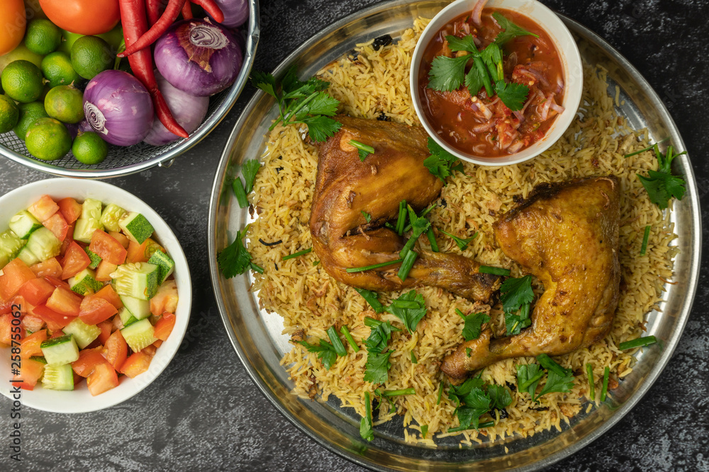 chicken mandy rice set with spicy sauce and salad on dark background ...