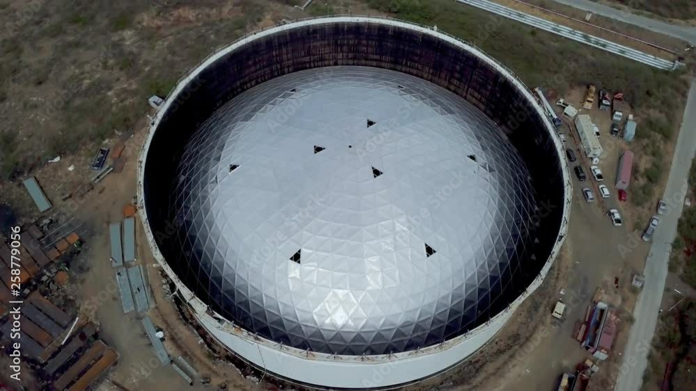 Crude oil storage tank from the air, high angle aerial pan of refinery ...