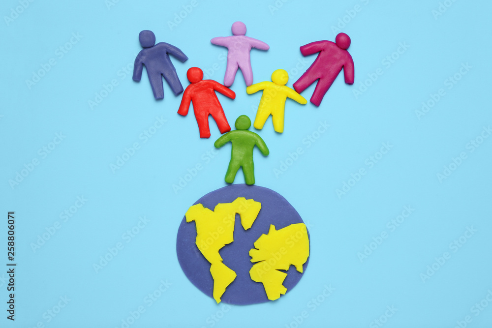 Plasticine multicolored cartoon people on globe. The use and depletion ...
