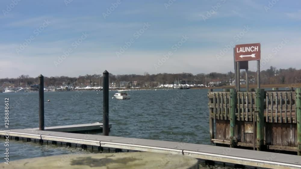 Sign that indicates where boats can LAUNCH in harbor. Wide shot of ...