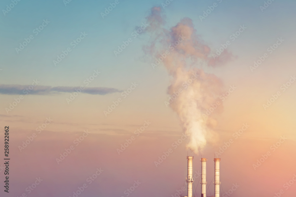 Three smoking stack pipes making clouds of white smoke with dramatic ...
