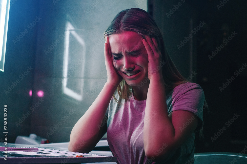 Drug obsession and pain. Drug addict holds hands on her hand and is ...