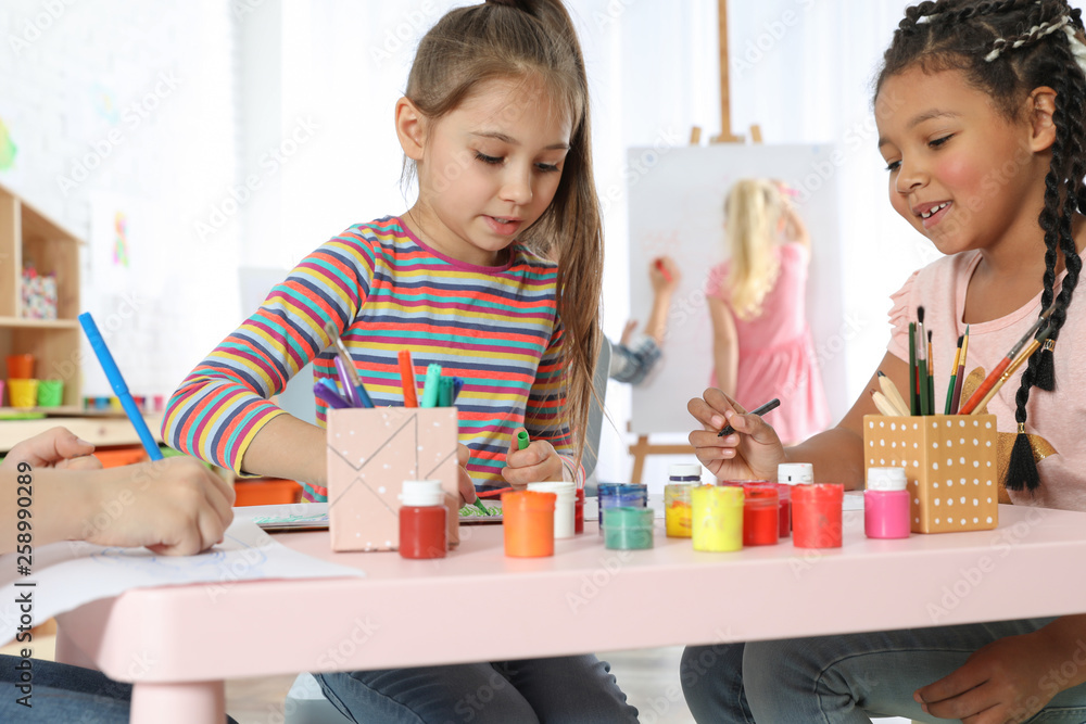 Cute little children drawing at painting lesson indoors Stock Photo ...