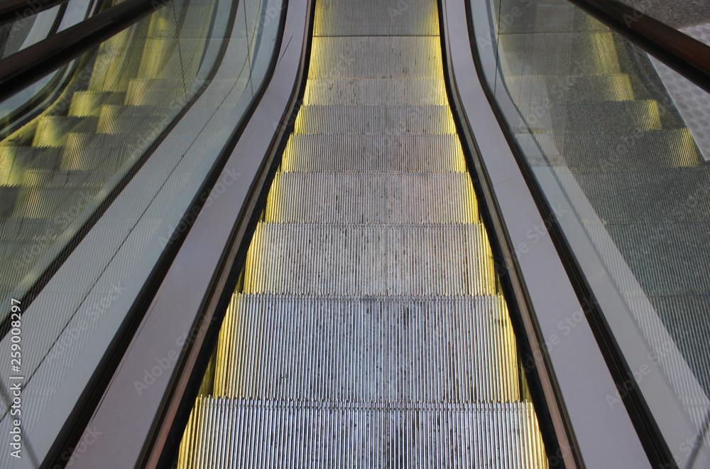 Escalator perspective in shopping mall or office building with modern ...
