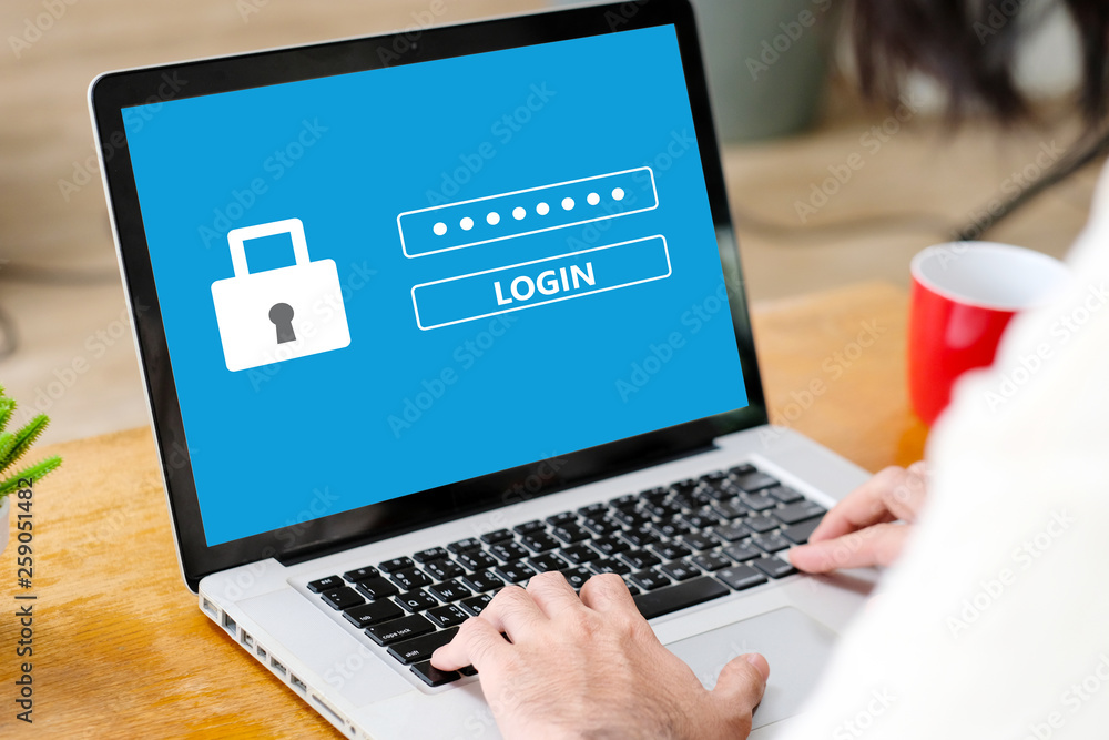 Hand tying laptop computer with password login on screen, cyber ...