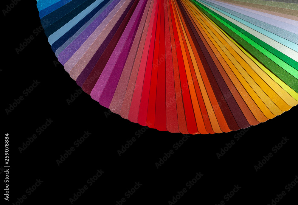Color fan deck with samples of various paint isolated on a black ...