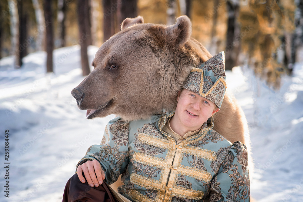 A man in traditional national costume of a Russian prince sits by a ...