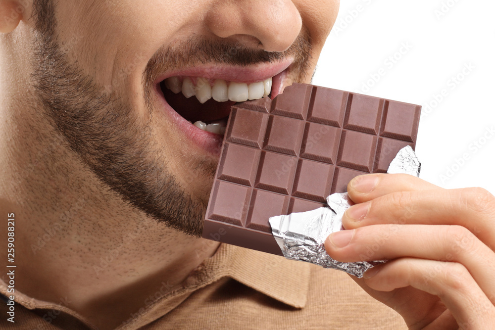 Man eating chocolate Stock Photo | Adobe Stock