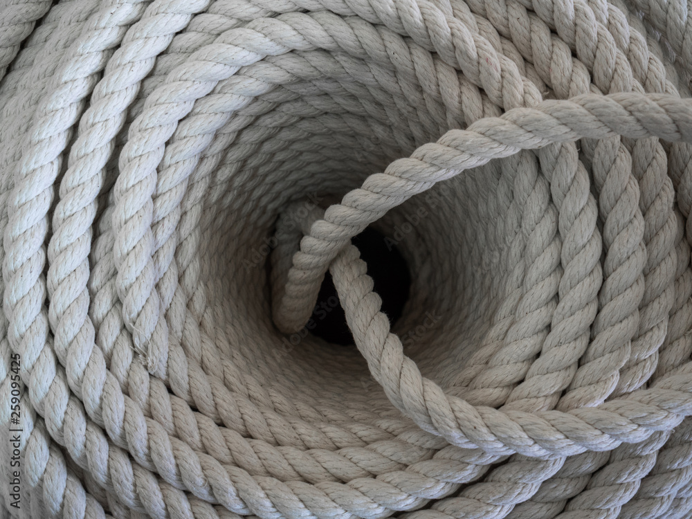 The thick rope twisted in a roll. The top view on a rope spiral. The ...