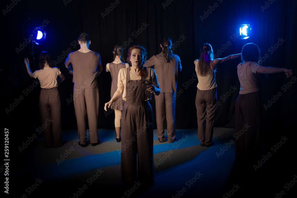 The actors on the stage play an emotion performance on a black ...