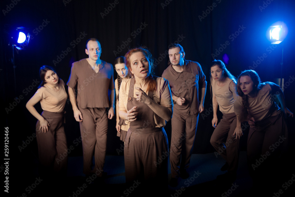 The actors on the stage play an emotion performance on a black ...