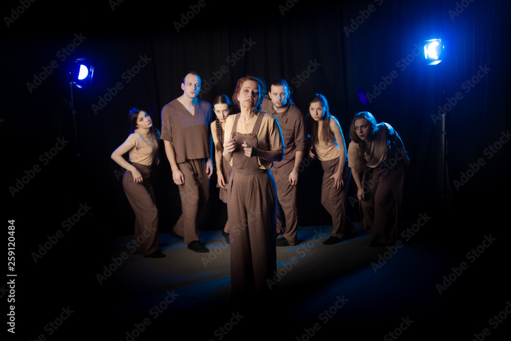 The actors on the stage play an emotion performance on a black ...