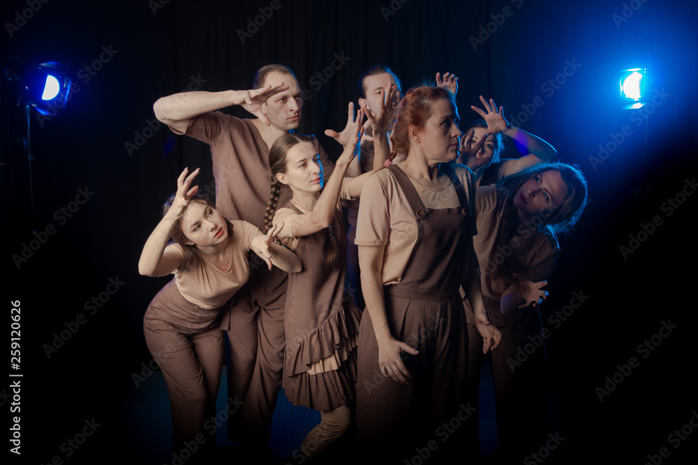The actors on the stage play an emotion performance on a black ...
