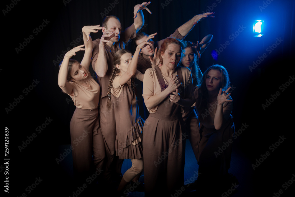 The actors on the stage play an emotion performance on a black ...