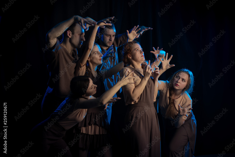 The actors on the stage play an emotion performance on a black ...