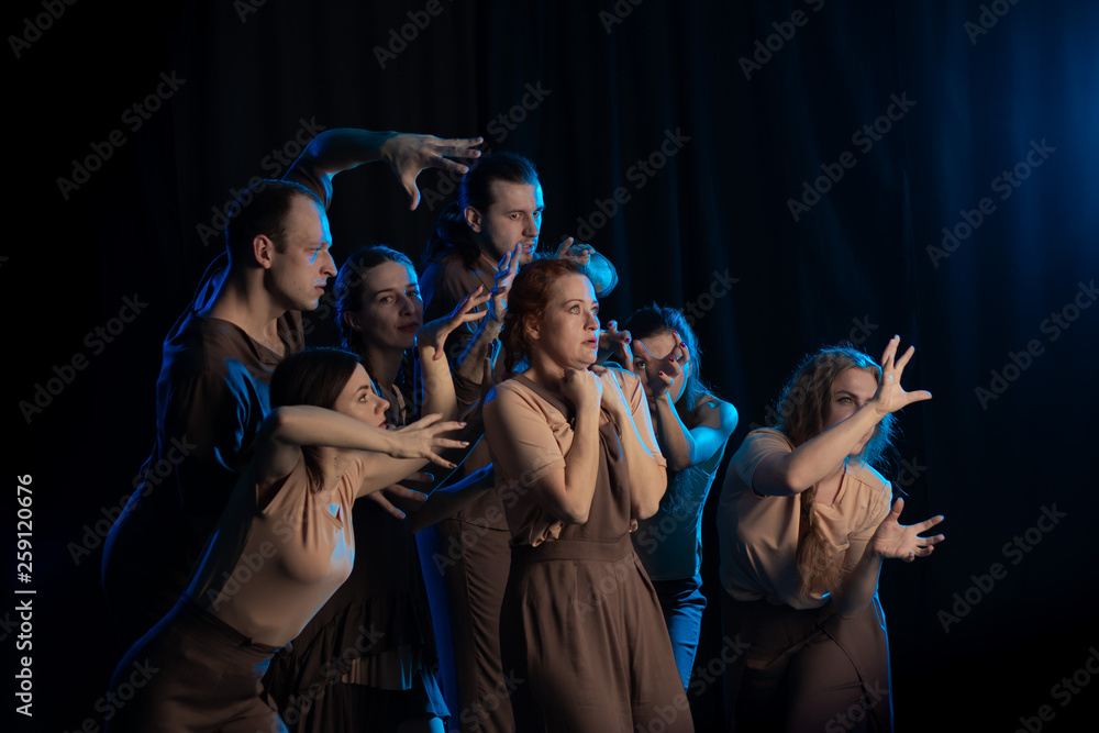 The actors on the stage play an emotion performance on a black ...
