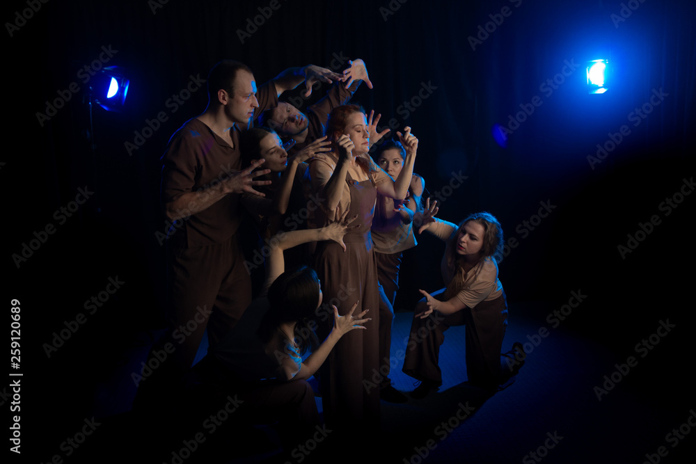 The actors on the stage play an emotion performance on a black ...