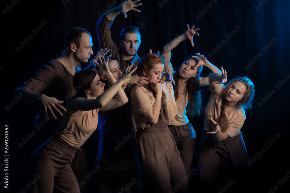 The actors on the stage play an emotion performance on a black ...