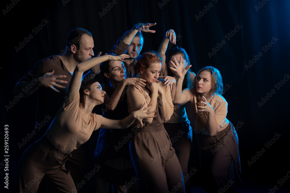 The actors on the stage play an emotion performance on a black ...