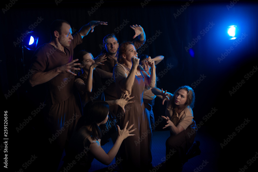The actors on the stage play an emotion performance on a black ...