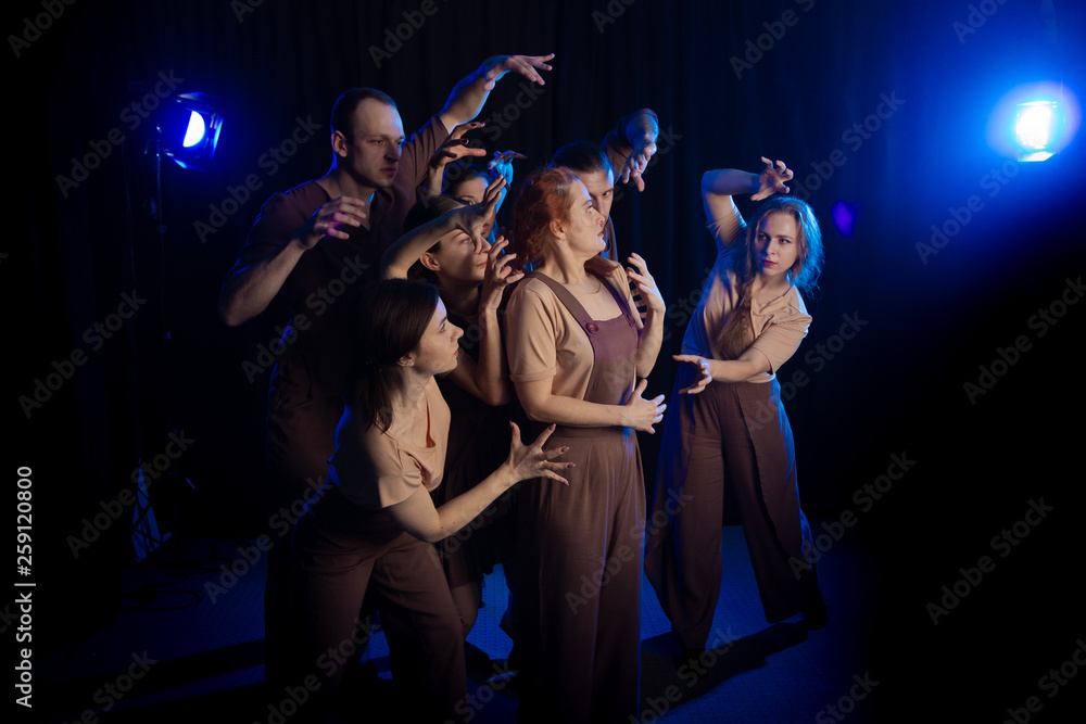 The actors on the stage play an emotion performance on a black ...