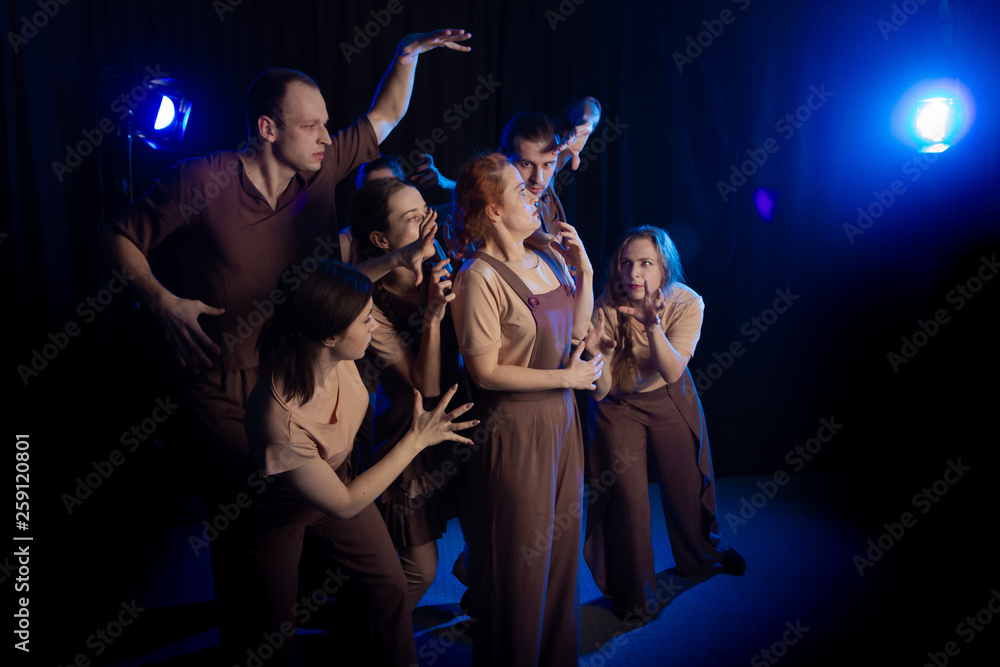 The actors on the stage play an emotion performance on a black ...