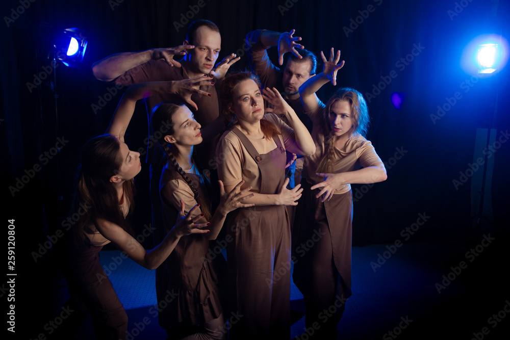 The actors on the stage play an emotion performance on a black ...